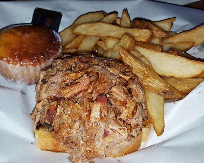 The pulled pork sandwich with hand-cut fries—a duo that belongs together like Astaire and Rogers. That golden pile of potatoes isn't a side; it's a co-star.