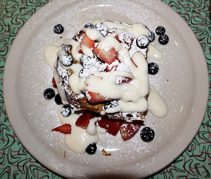 This isn't just French toast—it's a berry-crowned masterpiece drizzled with cream that transforms breakfast into an occasion worth celebrating.