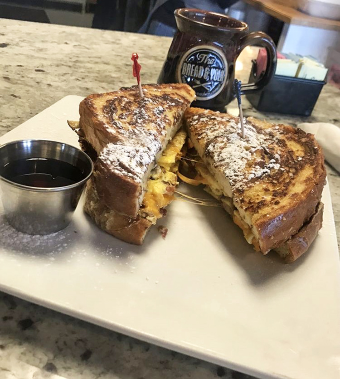 This isn't just French toast—it's a breakfast sandwich that went to culinary school. Note the perfect golden crust and generous maple syrup.