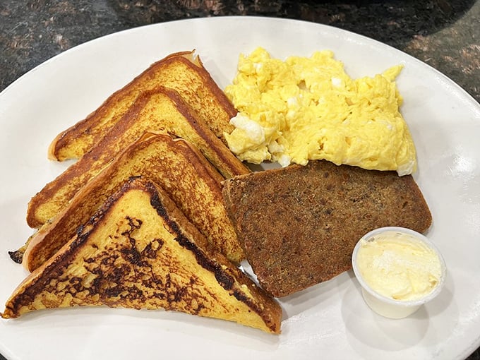 Golden-brown French toast that's achieved that mythical balance—crispy exterior, custardy interior. The scrapple alongside is pure Pennsylvania breakfast poetry.