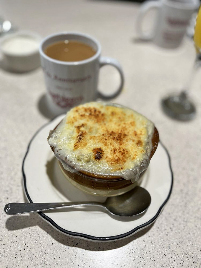 This isn't just French onion soup—it's a bubbling cauldron of comfort topped with a perfectly broiled cheese cap.