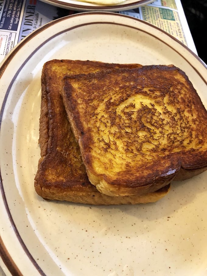 French toast that's achieved the perfect golden-brown exterior while maintaining that custardy interior – the breakfast equivalent of winning the lottery.