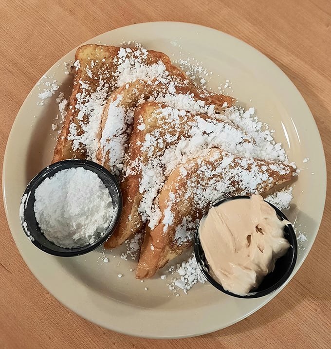 French toast dusted with powdered sugar and served with whipped cream – because sometimes breakfast should feel like getting away with dessert.