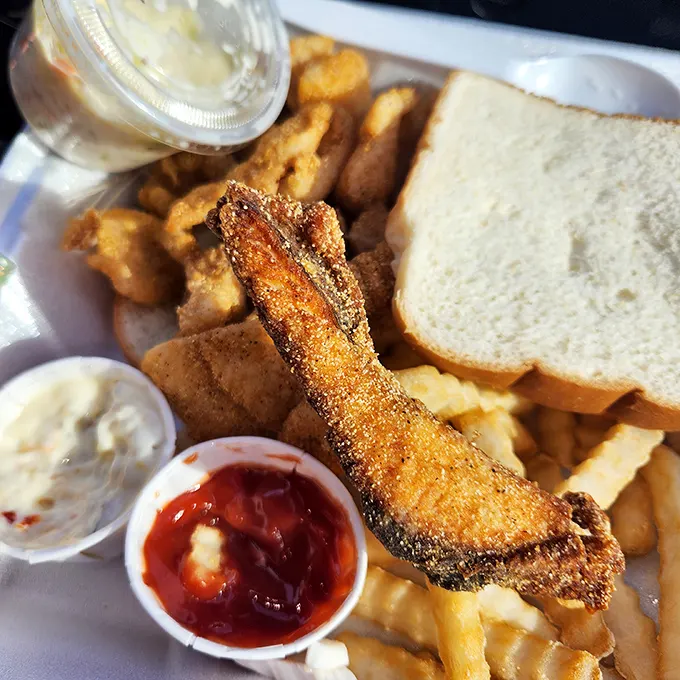 The perfect marriage of crispy cornmeal coating and flaky white fish, accompanied by bread that's ready for its supporting role in the last delicious swipe across your plate.