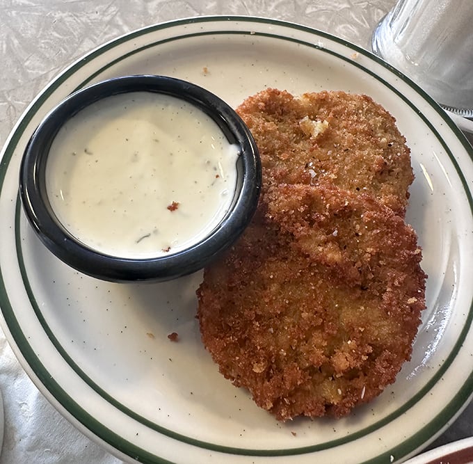 Golden-fried perfection meets creamy dipping sauce. This fried green tomato isn't just a side—it's the main event.