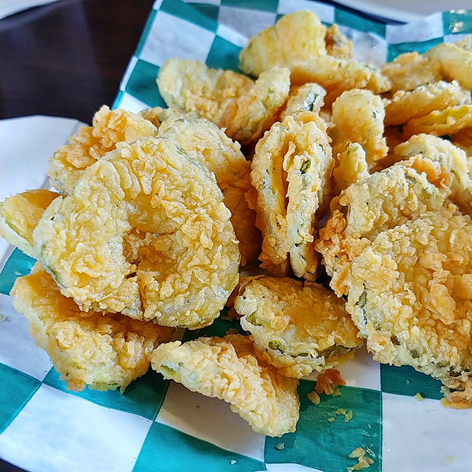 Fried pickles that crackle with each bite—the perfect marriage of tangy and crispy that makes you forget you're technically eating a vegetable.