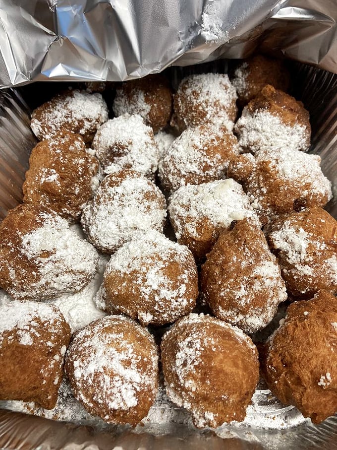 These powdered sugar-dusted fritters aren't trying to reinvent the wheel—they're just making it deliciously round, sweet, and impossible to eat without a smile.