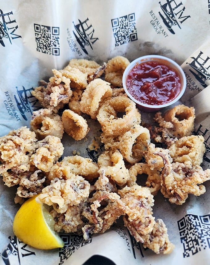 Fried calamari that's tender inside, crunchy outside – the way all good relationships should be. That lemon wedge isn't just for show, folks.
