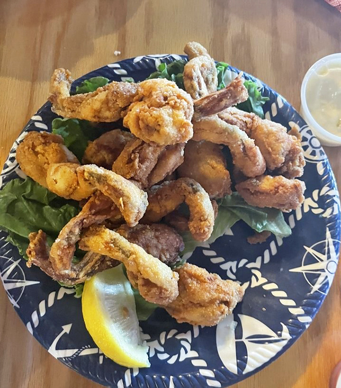 These aren't your average calamari rings. Perfectly fried and arranged like a delicate seafood bouquet, these treasures from the deep await their lemon squeeze.