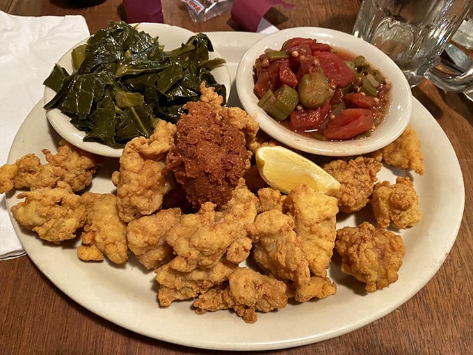 Golden-fried gator tail with collards and tomato relish—proof that sometimes the most authentic Florida experience isn't at a theme park, but on a dinner plate.