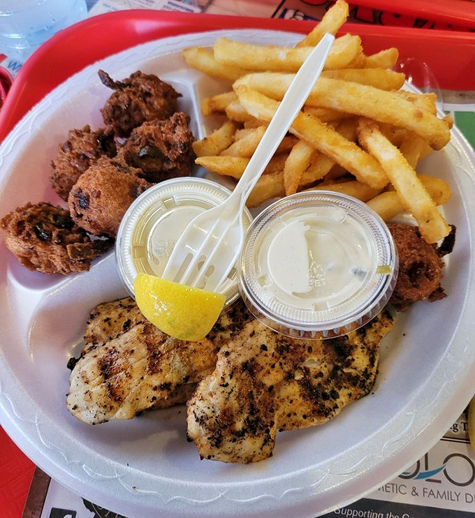 Perfectly blackened fish with a squeeze of lemon—proof that simplicity, when executed flawlessly, creates the most memorable meals. Those hushpuppies deserve their own fan club.