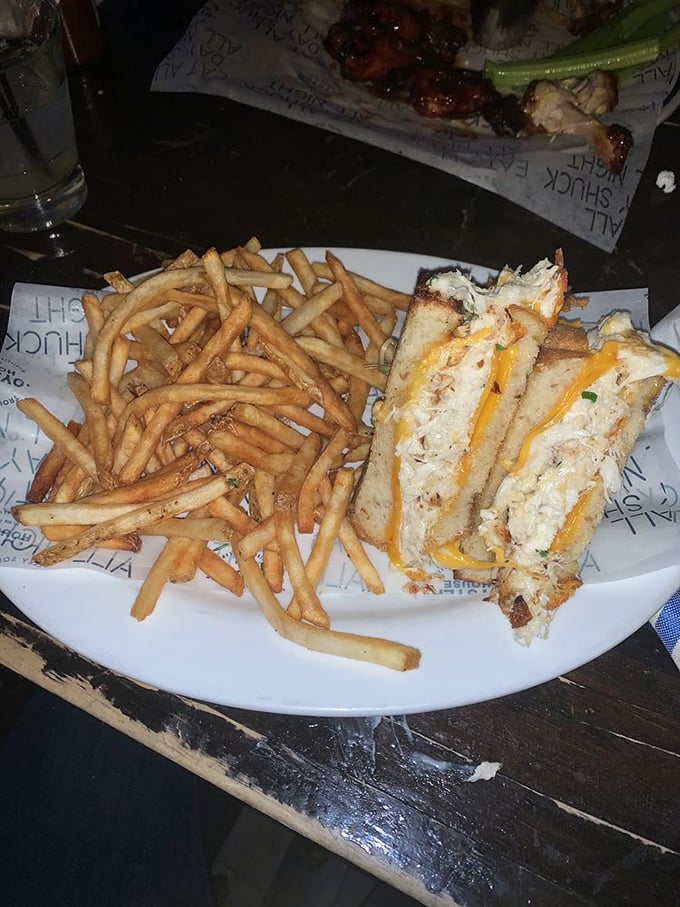 The legendary grilled cheese in its golden-brown glory, flanked by perfectly crisp fries. This sandwich doesn't just speak to your soul – it sings a full aria.