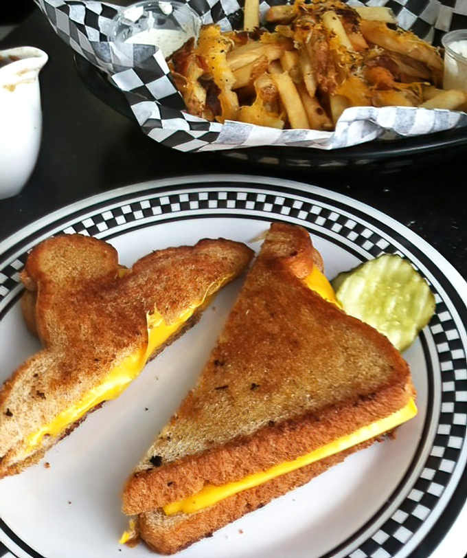 Grilled cheese elevated to art form—golden-brown perfection with melty American cheese that would make June Cleaver proud. Those fries deserve their own fan club.