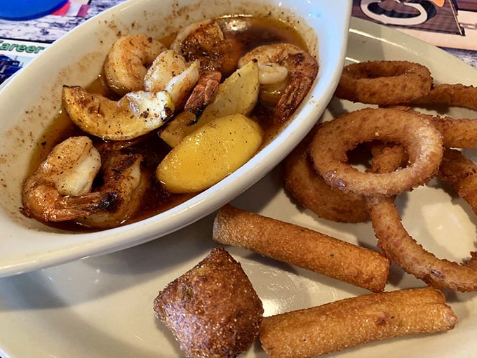 Butter-bathed shrimp swimming alongside crispy hushpuppies and onion rings—a trio that proves seafood in landlocked Missouri can be spectacular.