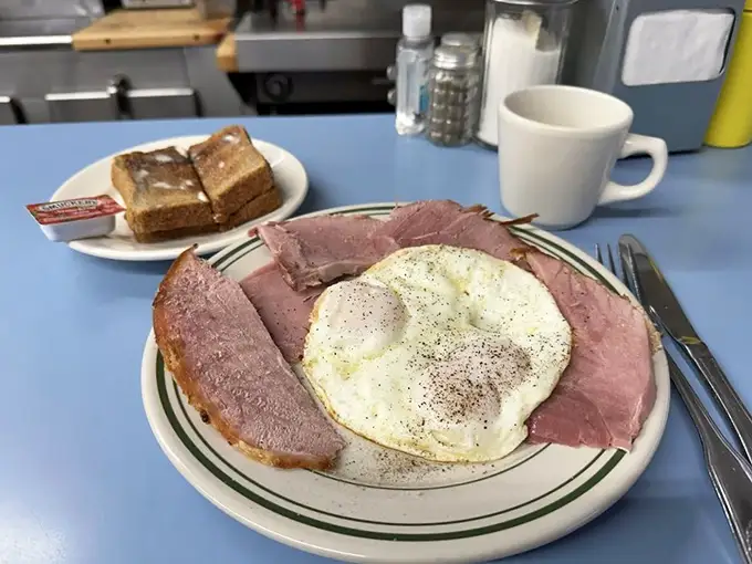 Breakfast perfection doesn't need a filter – just ham, eggs, and toast that would make your grandmother nod in approval.