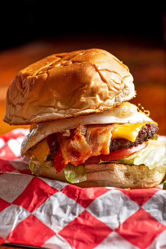 Meet the Hangover Burger – a towering masterpiece of beef, bacon, and egg that doesn't judge your life choices, just fixes them one bite at a time.