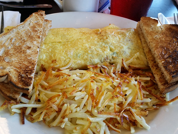 The perfect omelet doesn't exi— Oh wait, there it is, nestled beside hash browns so perfectly crispy they make that satisfying crunch with every bite.