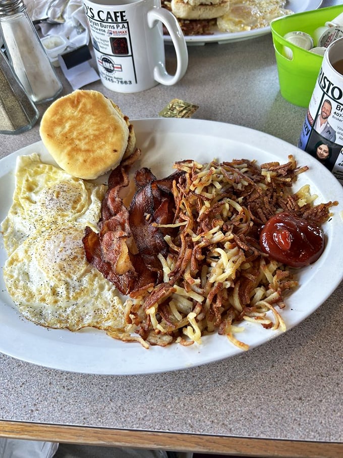 Breakfast of champions: eggs, crispy bacon, and hash browns that look like they've been kissed by the morning sun. That biscuit isn't just a side—it's an event.