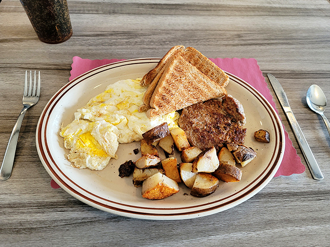 Breakfast platters that mean business! Golden-crisp home fries, eggs with perfectly runny yolks, and toast waiting for its butter bath—morning glory on a classic diner plate.