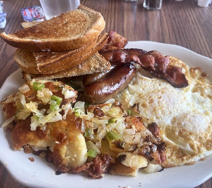 This isn't just breakfast; it's edible therapy—crispy potatoes mingling with eggs while toast stands by, ready for yolk-dipping duty.