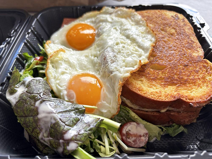 Two sunny-side-up eggs perched atop a garden of greens and toast – proof that breakfast can be both photogenic and life-changing.