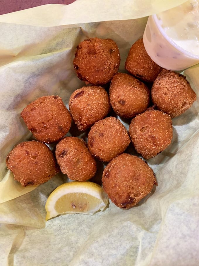 These golden-brown hush puppies aren't just side dishes—they're crispy cornmeal orbs of joy that demand a squeeze of lemon and complete silence while savoring.