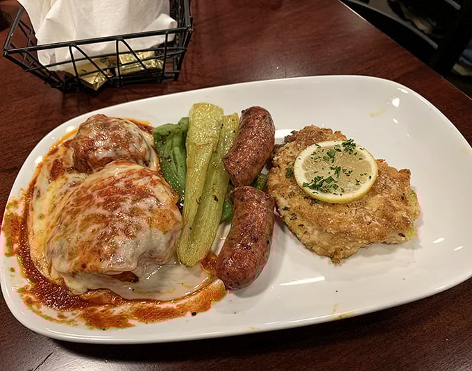 A feast for the indecisive: chicken parmesan, Italian sausage, and veal piccata share a plate with perfectly cooked vegetables—the Italian version of "having it all."