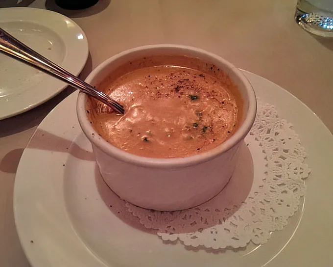 Not just any lobster bisque—this velvety coral-hued elixir delivers the essence of the ocean in each spoonful. Poseidon's favorite soup, surely.