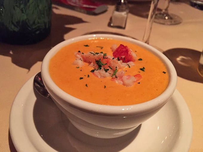 This lobster bisque isn't merely soup—it's liquid velvet with a copper hue, topped with tender morsels of its namesake. The ultimate comfort food with a tuxedo on.