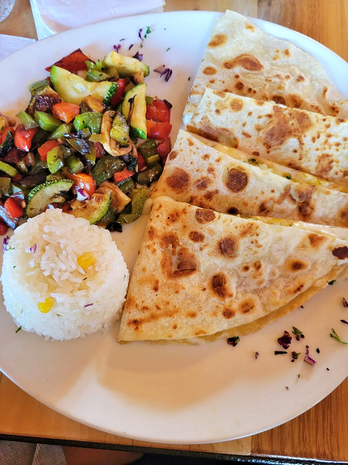 A quesadilla that means business, flanked by colorful grilled vegetables and rice that's actually worth eating instead of pushing aside.