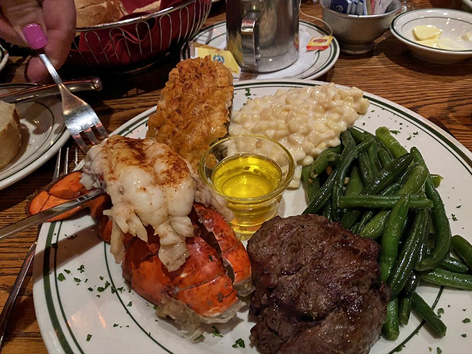 Surf meets turf in this showstopper—a lobster tail that practically high-fives your steak while creamed corn and green beans provide moral support.