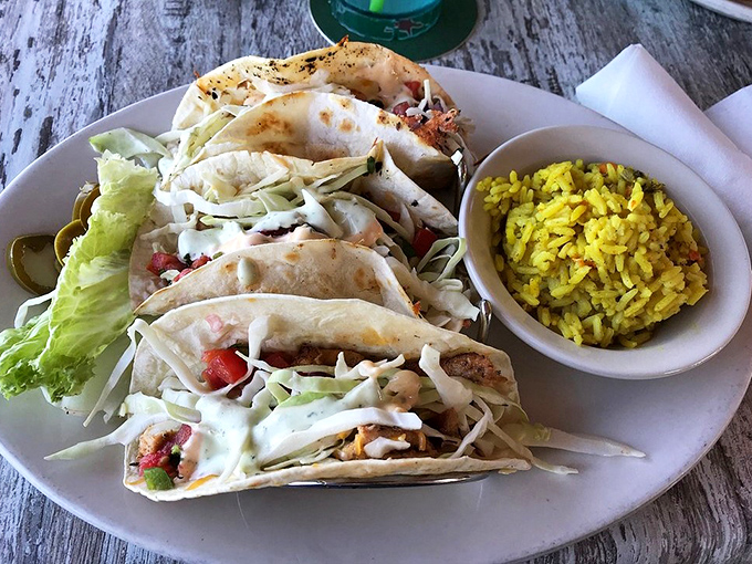These fish tacos aren't just a meal – they're a vacation on a plate, complete with sunshine-colored rice that tastes like Florida in every grain.