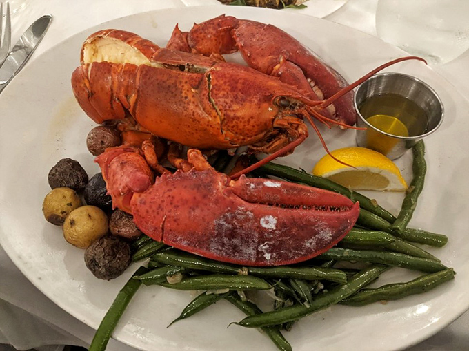 This steamed Maine lobster isn't just dinner – it's an event, complete with potatoes, green beans, and that little cup of liquid gold.