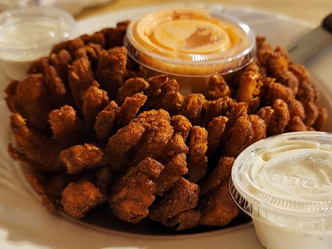 The Mayflower Onion isn't just an appetizer—it's a crispy, golden flower that blooms right on your plate, begging for a dip.