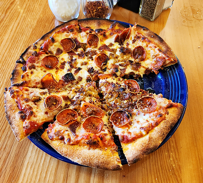 This isn't just pizza—it's a circular manifesto of crispy-edged, cheese-bubbling perfection topped with pepperoni that curls into flavor cups.