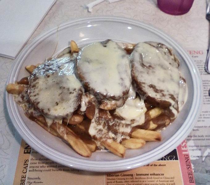 Comfort food that would make your grandmother jealous—tender meatloaf smothered in gravy atop a mountain of fries. Diet plans come here to die gloriously.