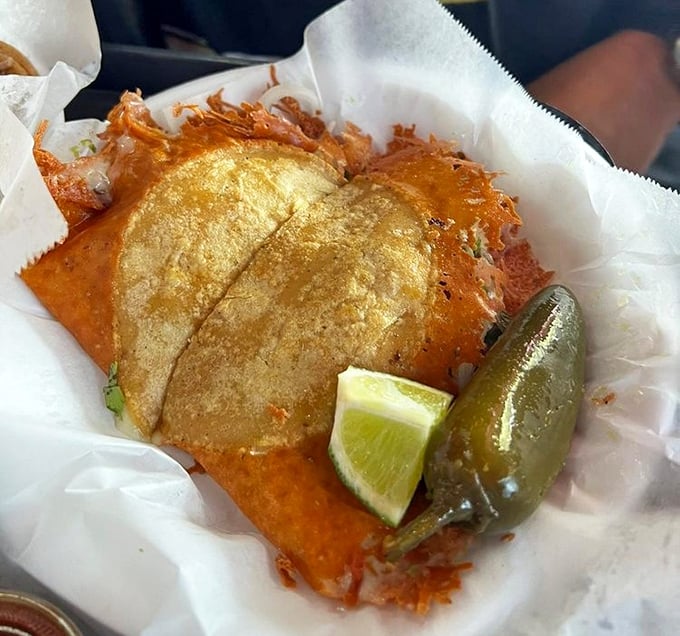 The Mulita Aporkalypse arrives like a crispy, cheese-laden postcard from heaven, complete with a lime wedge and jalapeño exclamation point.