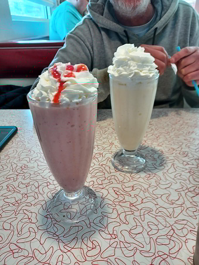 These aren't just milkshakes—they're desserts masquerading as beverages. The strawberry version comes with its own red carpet of syrup.