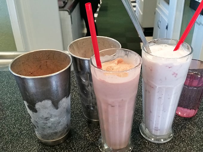 These milkshakes don't just bring boys to the yard—they've been bringing families to Dewar's for decades, served in those classic metal mixing cups.