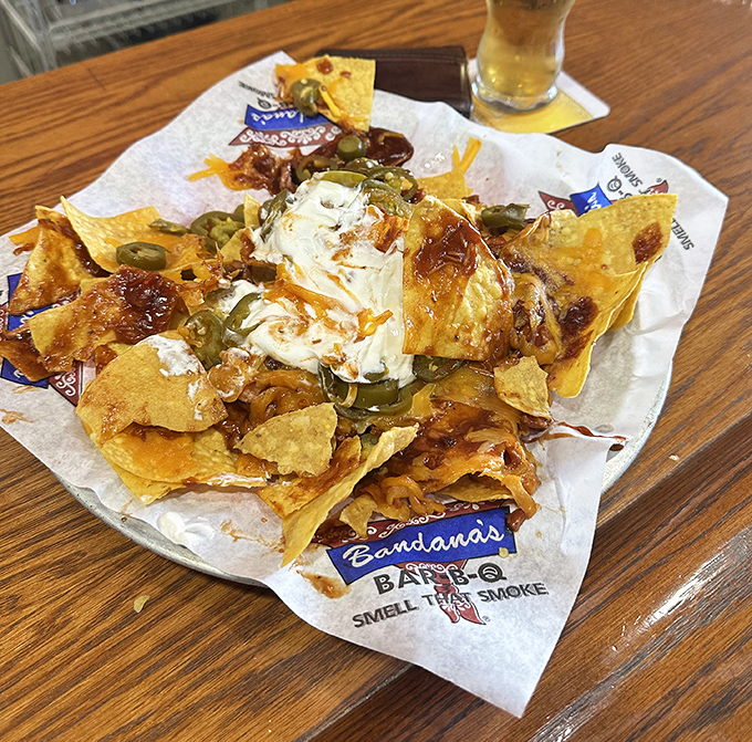 These aren't your average nachos – they're a mountain of chips crowned with pulled pork, jalapeños, and enough cheese to make Wisconsin proud.