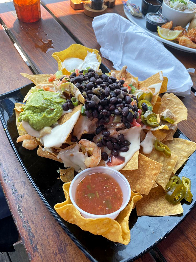 These nachos aren't messing around—loaded with black beans, queso, and seafood in quantities that suggest the chef might actually like you.