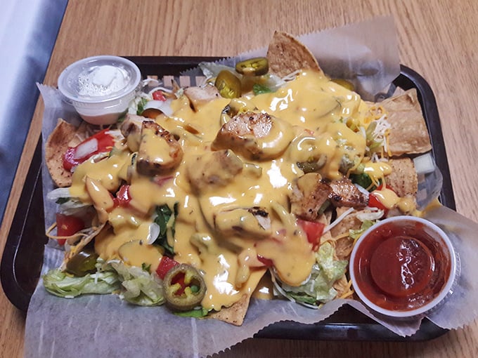 Nachos that require a strategy meeting before eating—where every chip is a treasure map leading to the perfect combination of cheese, jalapeños, and grilled chicken.