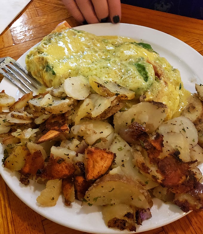 The omelet that launched a thousand forks. Perfectly folded around fresh vegetables and served with a mountain of seasoned potatoes that disappear mysteriously fast.