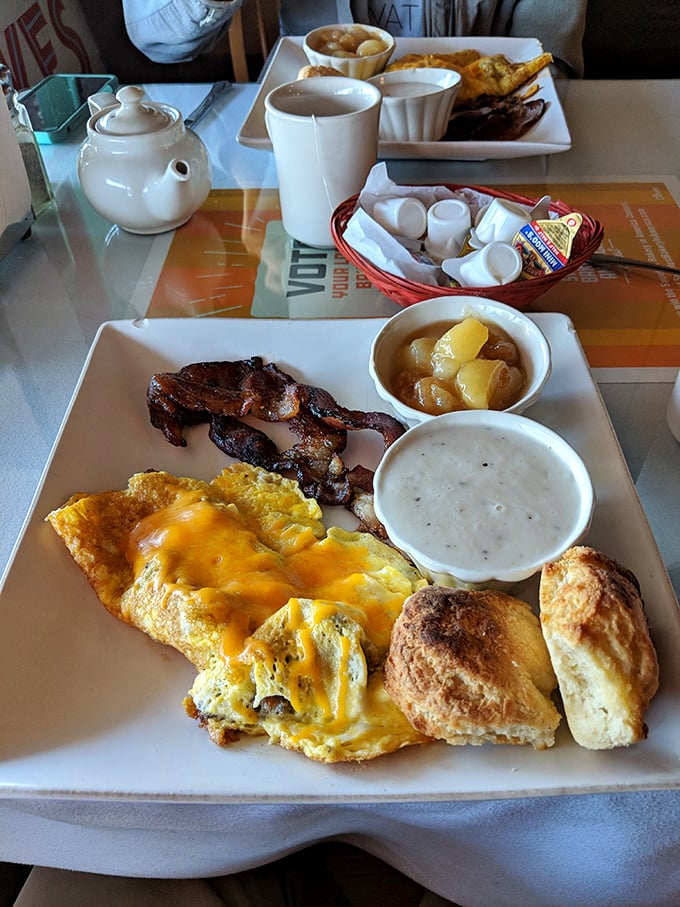 This isn't just breakfast—it's edible therapy. Fluffy eggs, crisp bacon, homemade biscuits, and gravy that could make a vegetarian reconsider their life choices. 