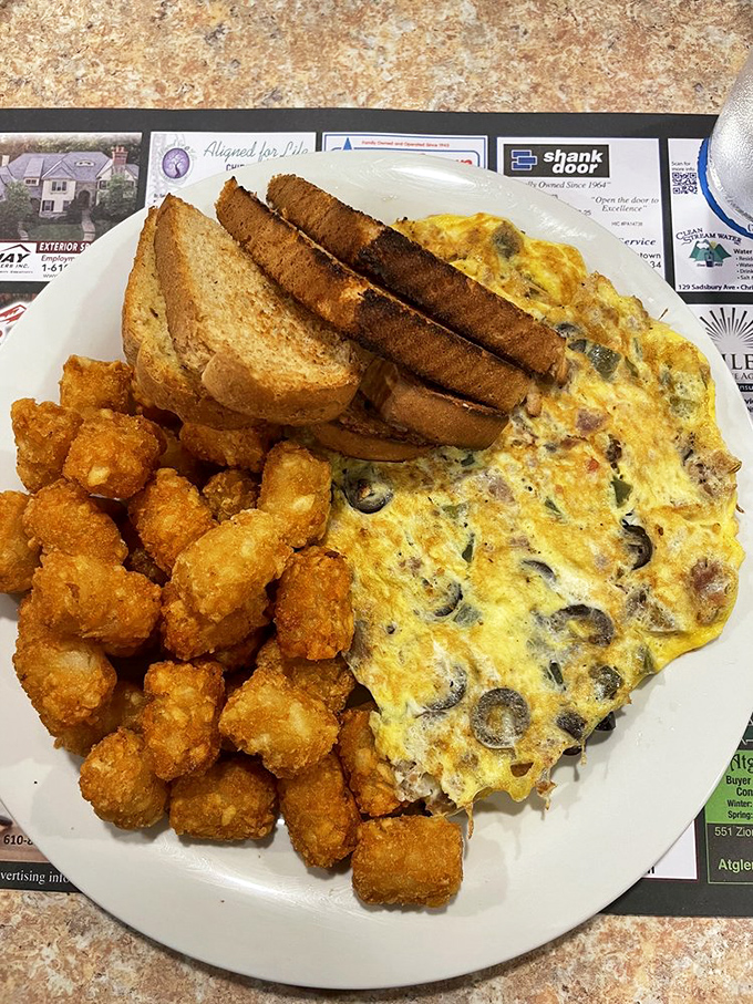 The omelet that launched a thousand road trips. Those crispy hash browns aren't just a side dish—they're the supporting actor who steals the show.