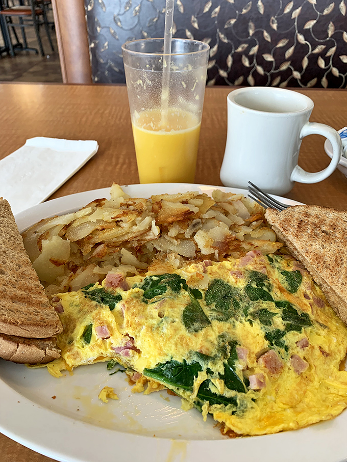 This spinach and ham omelet isn't just breakfast—it's edible artwork. Paired with crispy home fries and whole wheat toast for morning perfection.