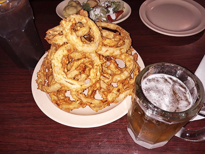 These onion rings aren't just a side dish—they're golden halos of crispy perfection that could make even devoted health nuts abandon their principles.