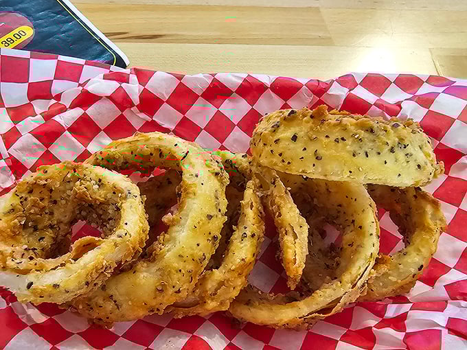 These aren't just onion rings—they're edible halos of crispy perfection. The seasoning alone should have its own fan club.