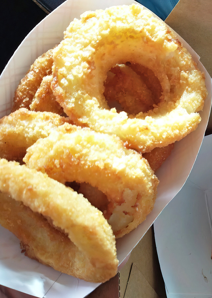 Golden halos of happiness—these onion rings achieve that perfect crunch-to-softness ratio that has launched a thousand road trips.