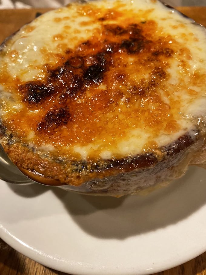 Cheese that stretches toward heaven—the onion soup here isn't just served, it's performed. That golden, bubbling crust is basically the Broadway finale of comfort food.